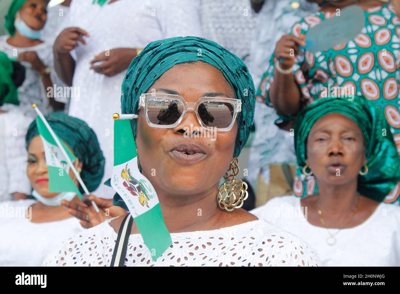 Women hold Nigerian flags, sing during Nigeria’s 61st Independence Day ...