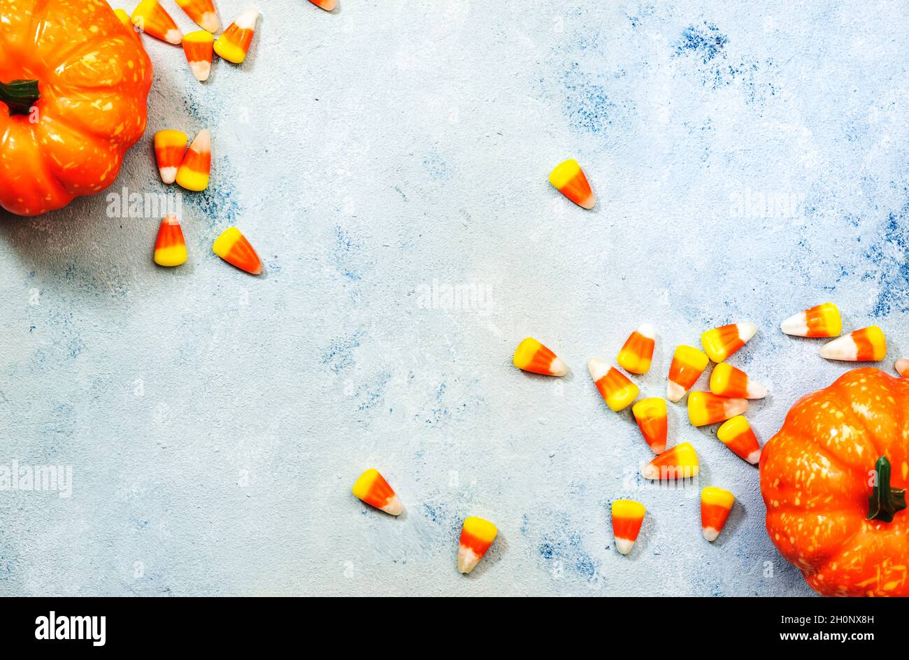 Halloween pumpkin and candy corn banner on blue baclground. Top view ...