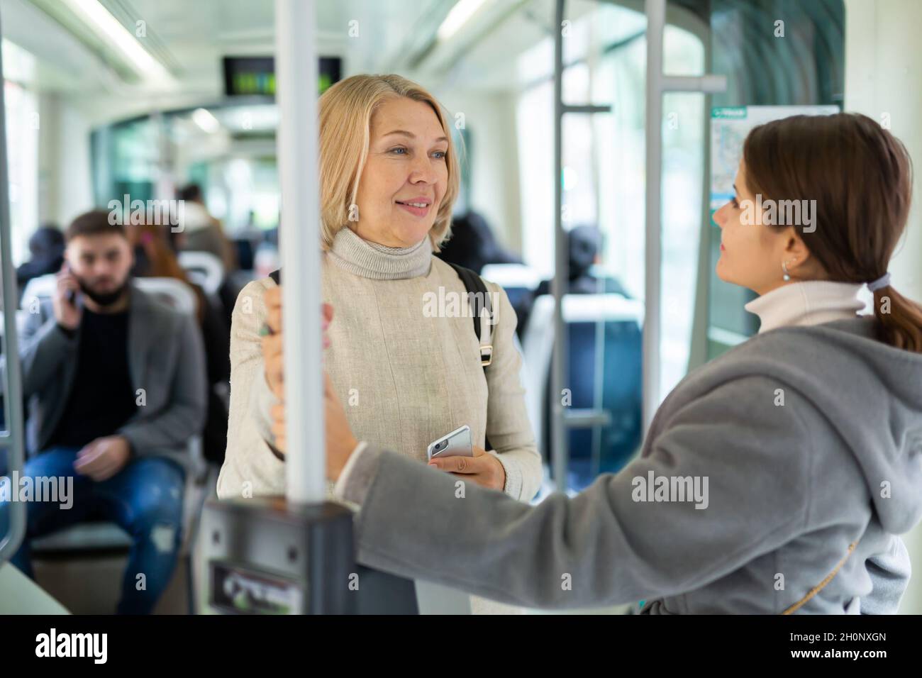 Woman riding tram talking hi-res stock photography and images - Alamy
