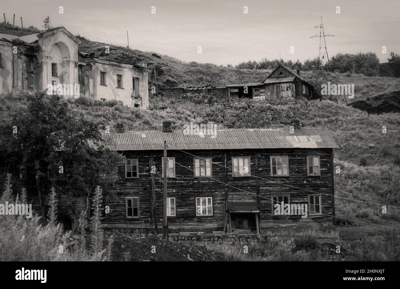Old abandoned wooden two storey building in deserted old town or ...