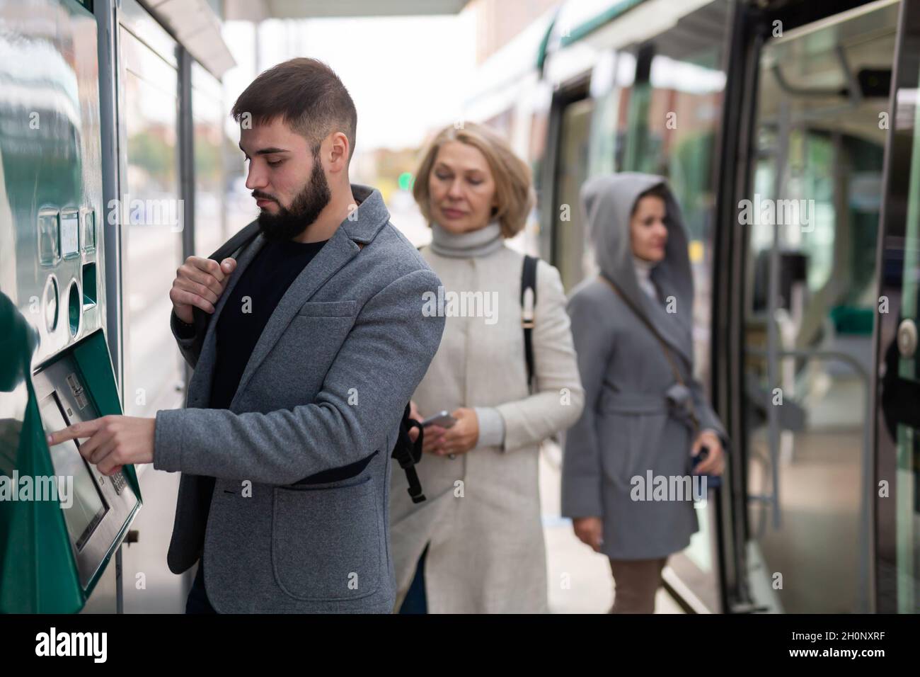 Man using ticket vending machine Stock Photo - Alamy