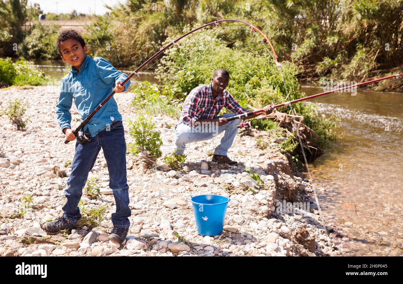 Boy pulling fish Stock Photo - Alamy