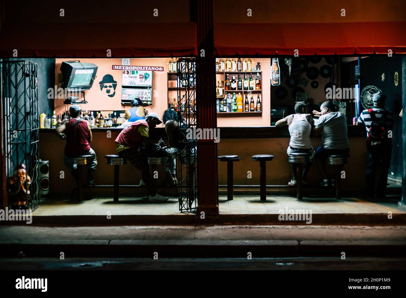 Nightlife in Havana, locals drink and mingle at an open street bar in ...