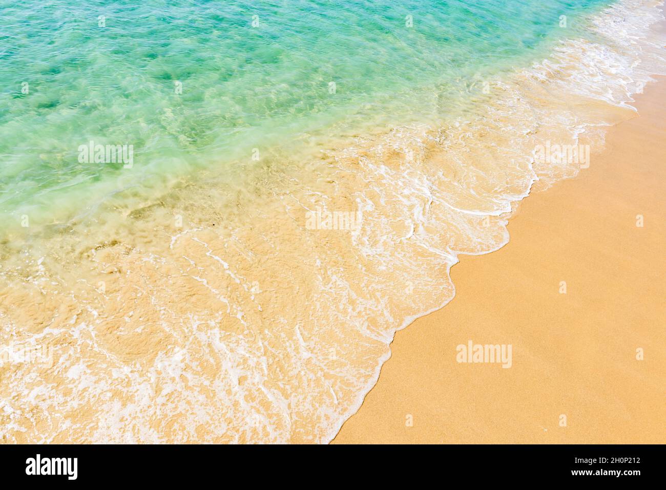Sea waves of beautiful smooth sandy beach Stock Photo - Alamy