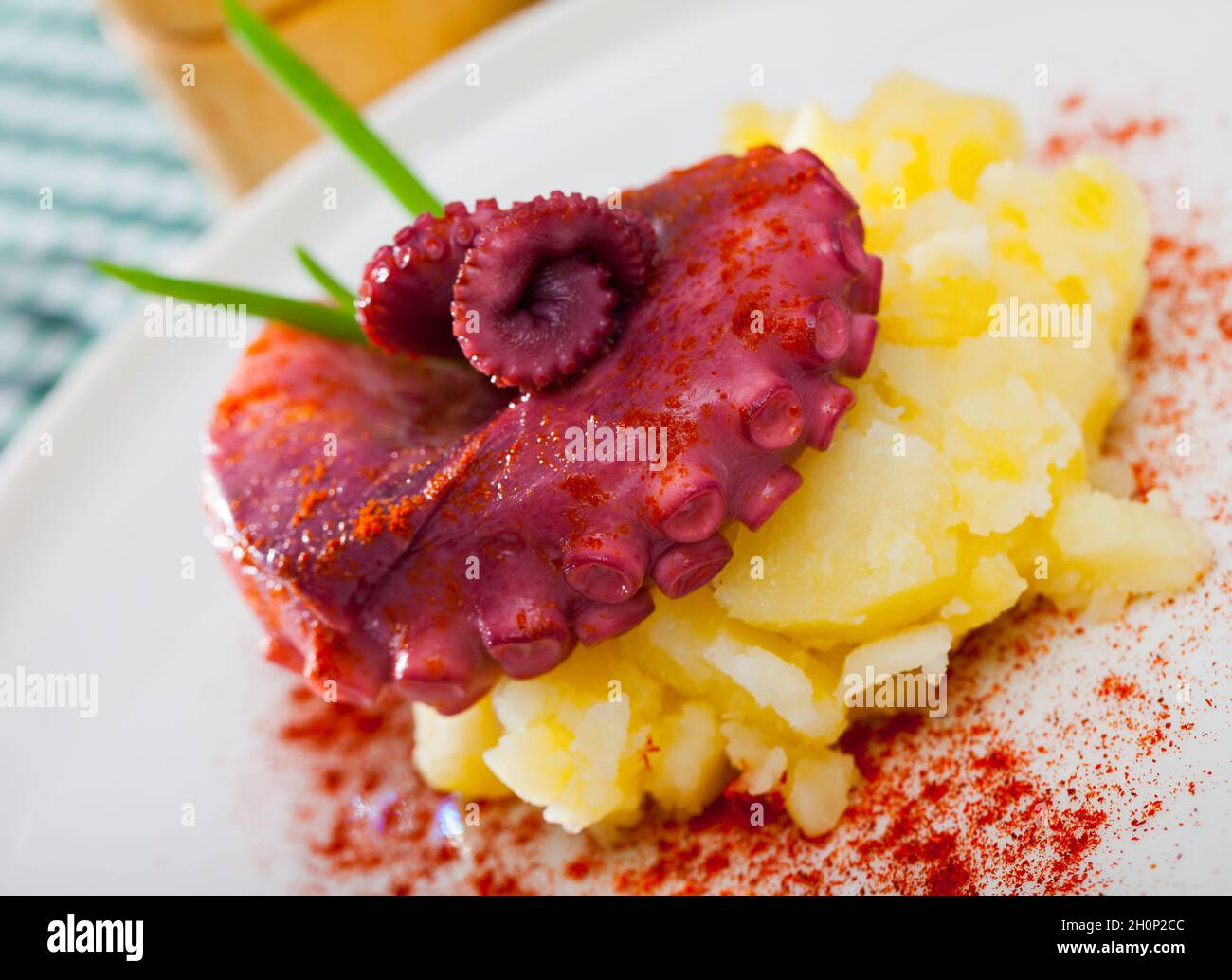 Baked octopus tentacle with potatoes Stock Photo - Alamy