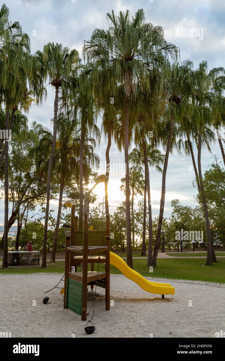 Playground with slide near palm trees and estuary Stock Photo - Alamy