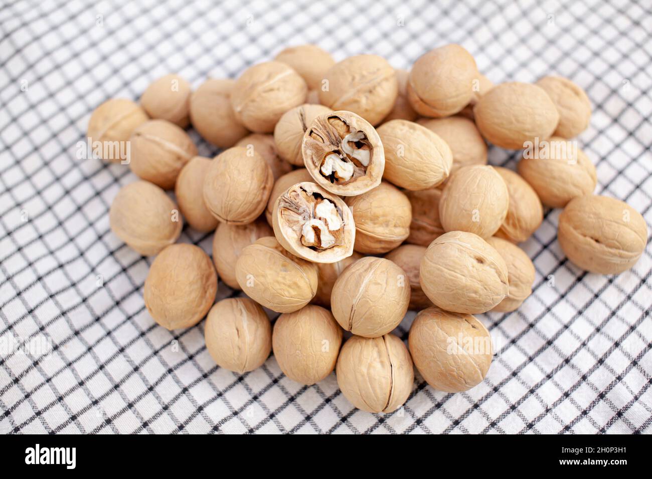 A lot of whole walnuts on a napkin close-up. Healthy, organic and ...