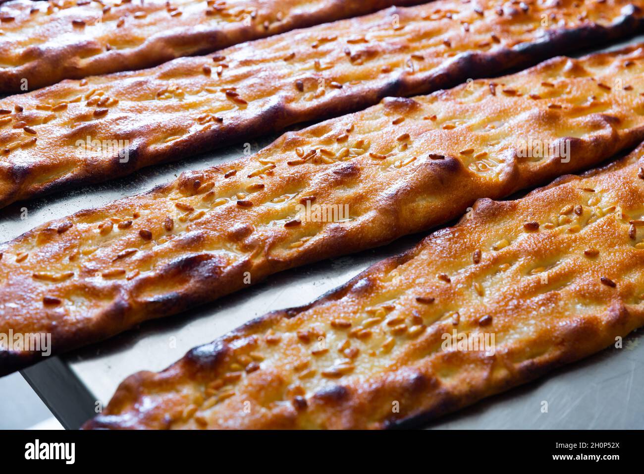 Appetizing hot sesame bread called coca Stock Photo - Alamy