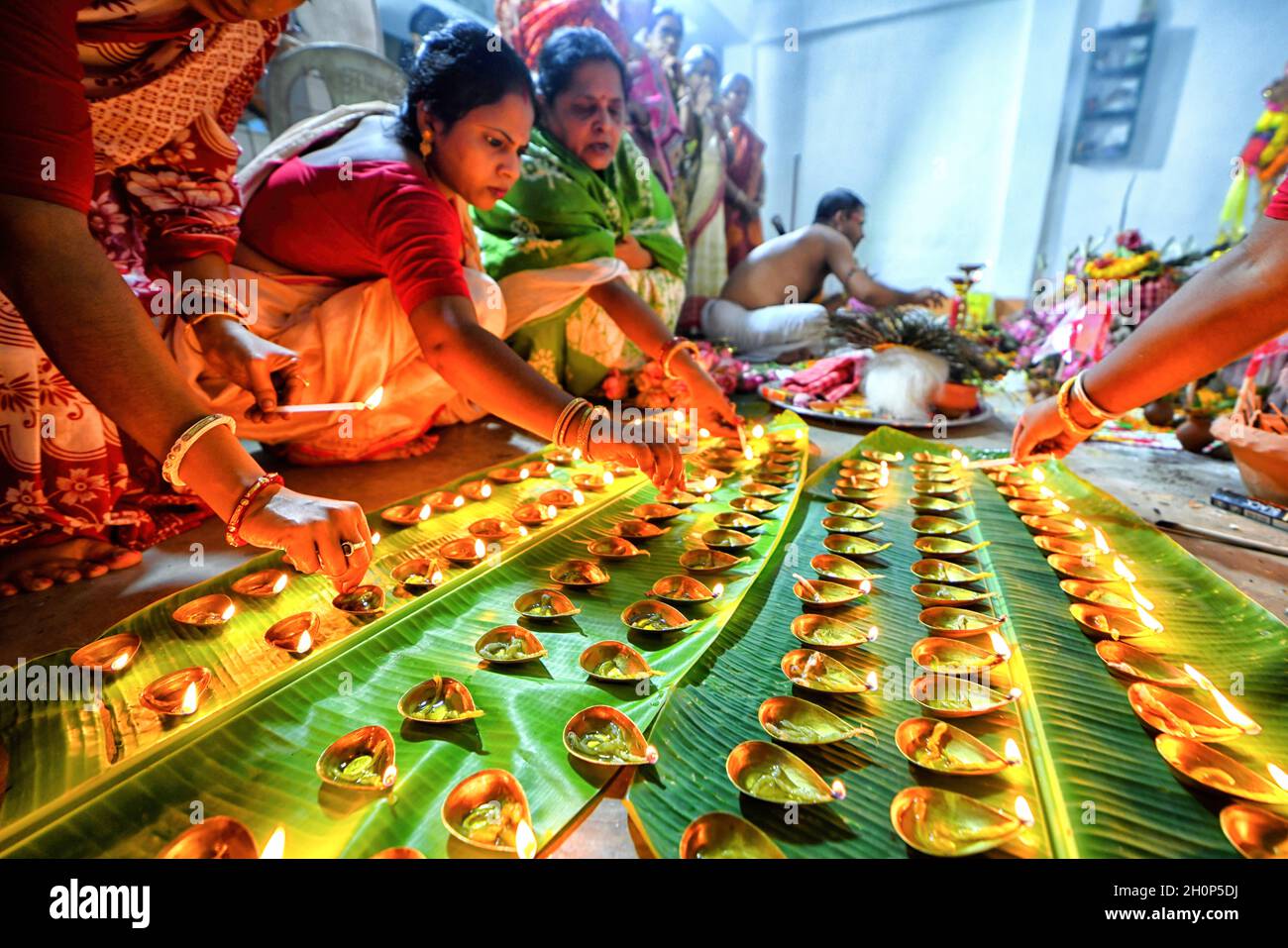 Kolkata, India. 13th Oct, 2021. Hindu devotees light Diyas (clay lamps ...