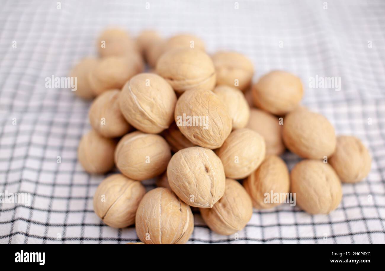 A lot of whole walnuts on a napkin close-up. Healthy, organic and ...