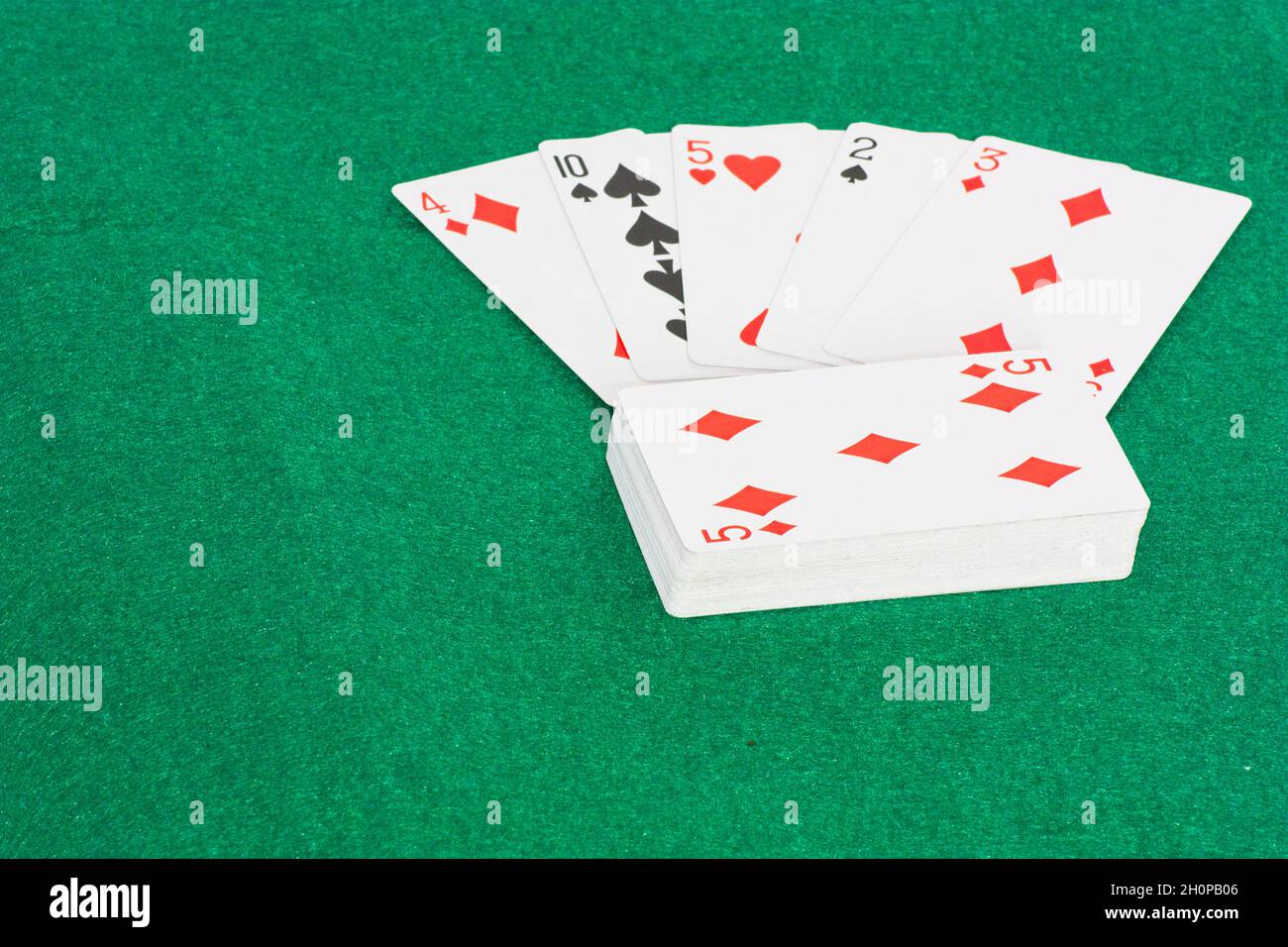 A deck of cards laid out on a green background Stock Photo - Alamy