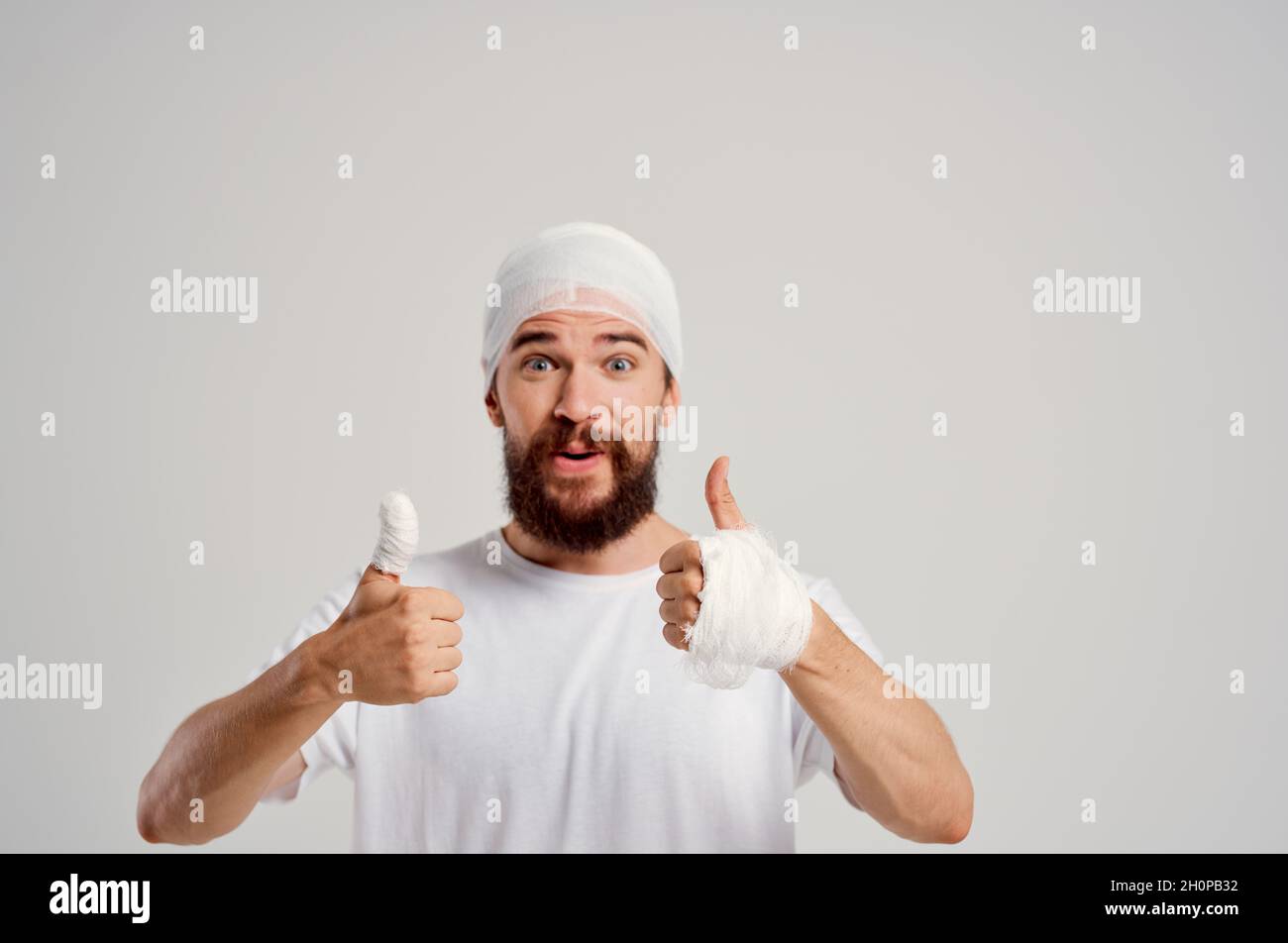 Man with a bandaged head and an eye blood light background Stock Photo ...