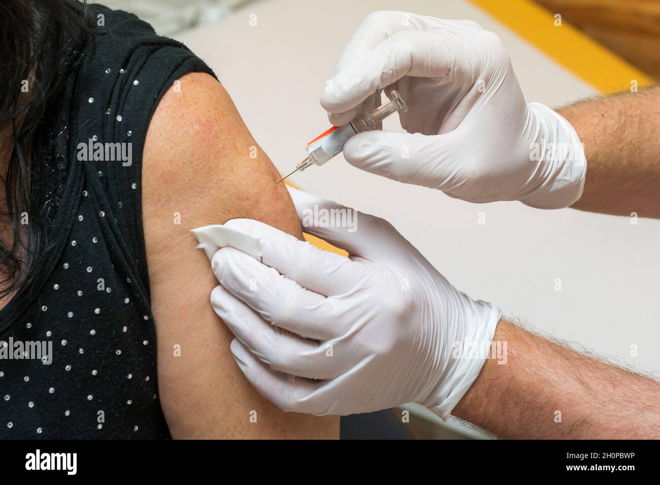 The injection for the flu vaccination is given in the upper arm Stock ...