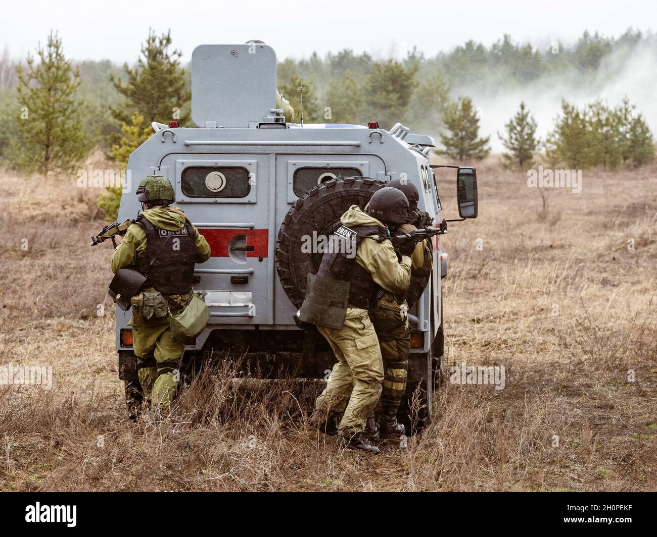 OMON (riot police) officers move through unfamiliar terrain under the ...