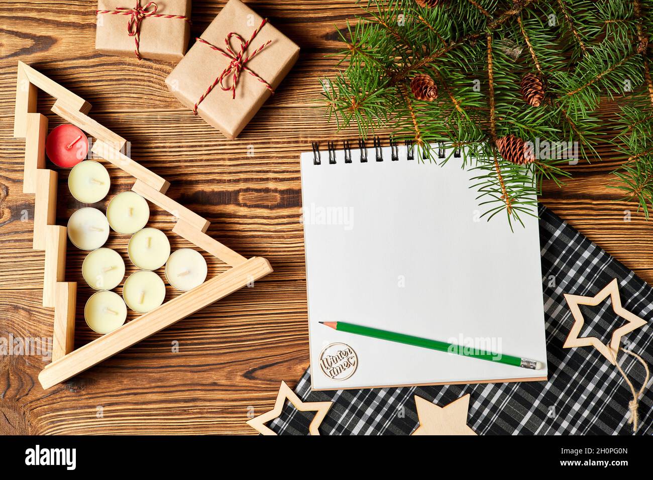 Wooden christmas tree with candles inside, with gift boxes, fir ...