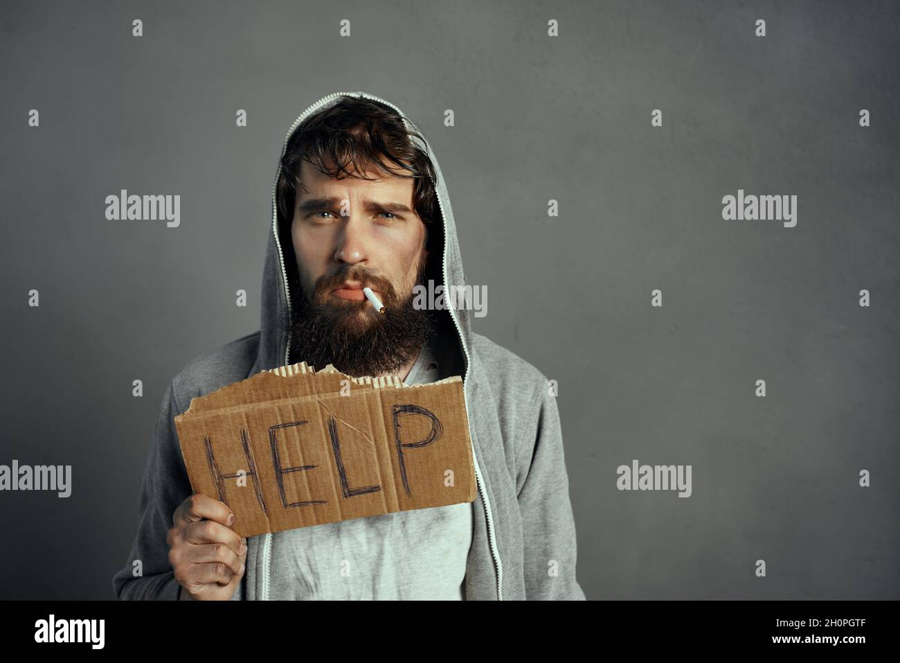 bearded homeless man holding a sign Help emotions poverty on the street ...