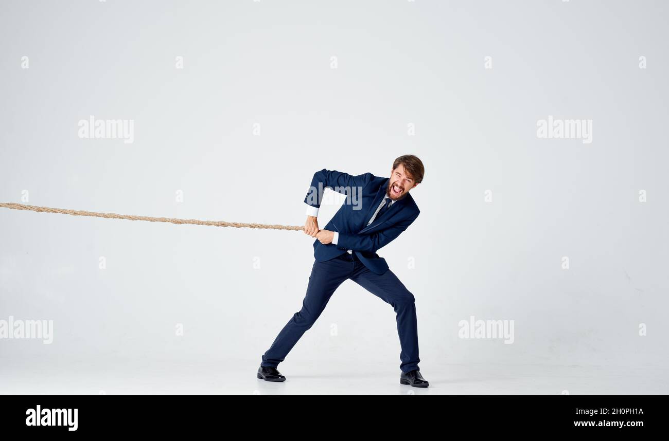 business man in a suit with a rope in his hands manager office light ...