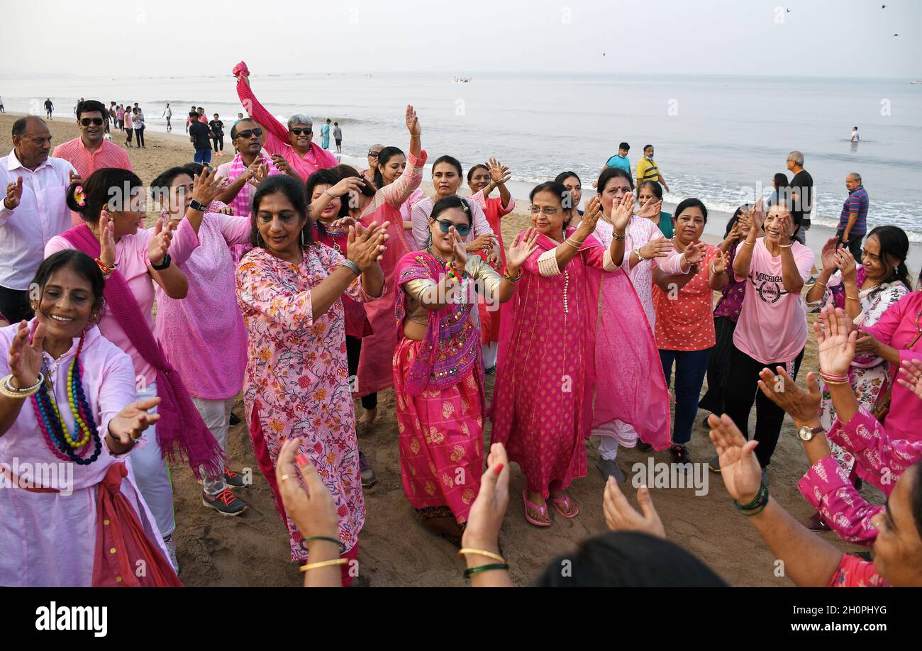 Mumbai, India. 14th Oct, 2021. Women wearing pink dresses perform Garba ...