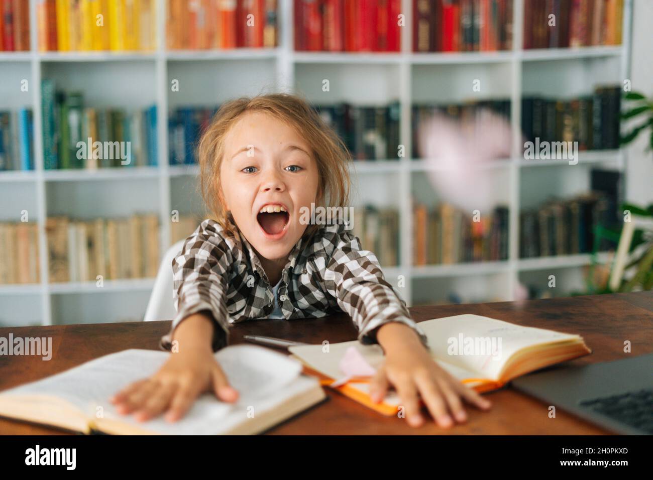 Close-up front view of smiling pretty pupil child school girl fooling ...