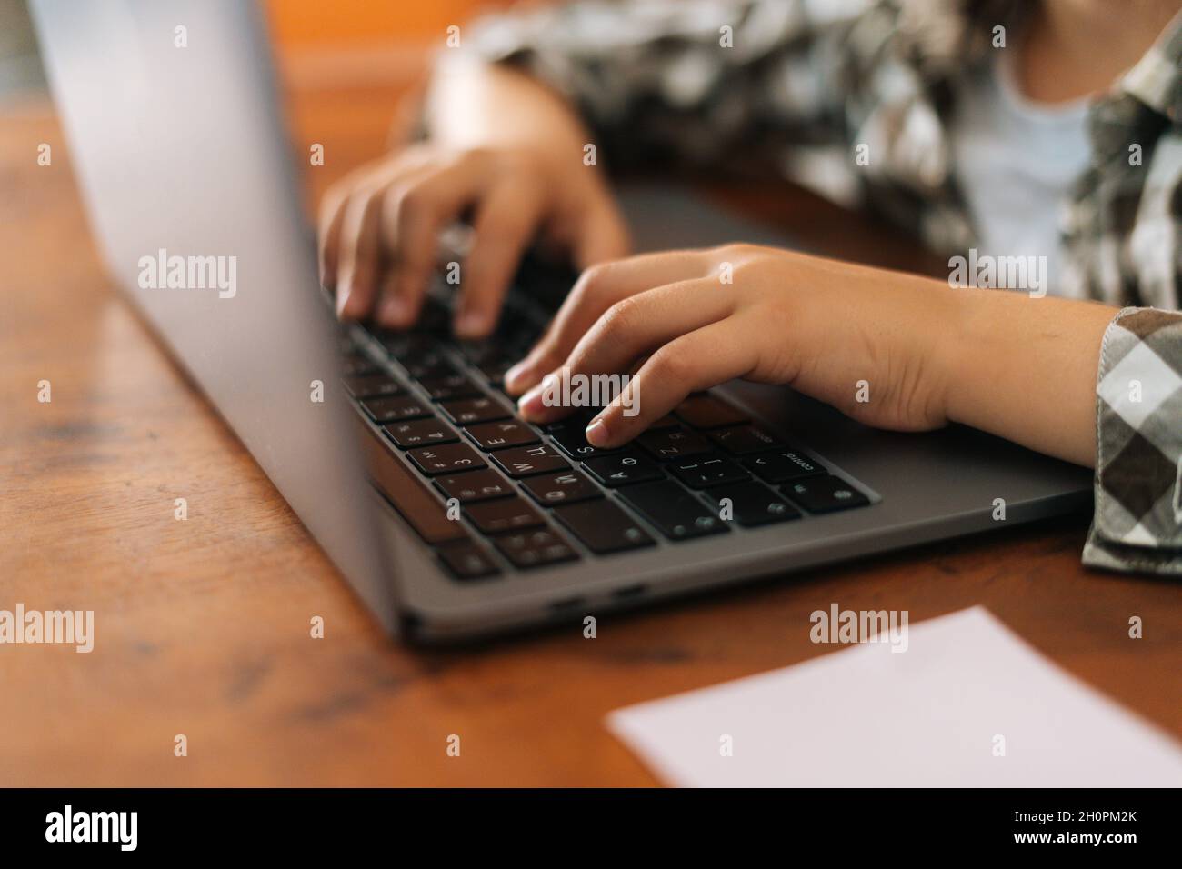 Close-up side view hands of unrecognizable elementary child school girl ...