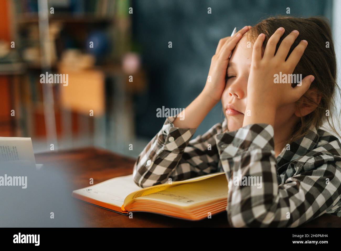 Close-up side view of sad exhausted primary child school girl tired ... Close-up side view of sad exhausted primary child school girl tired ...