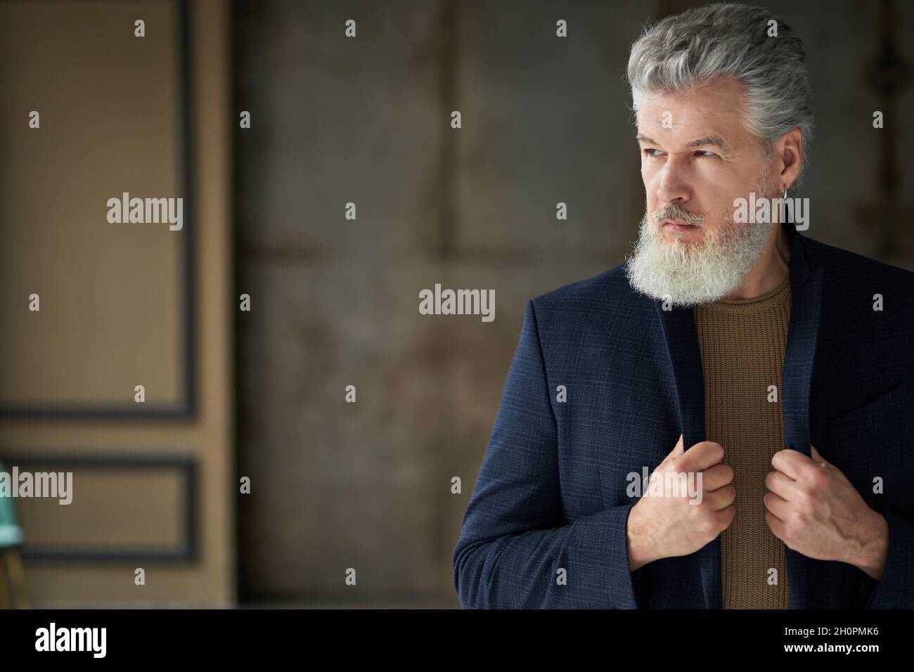 Stylish serious handsome middle aged man looking away, adjusting his ...