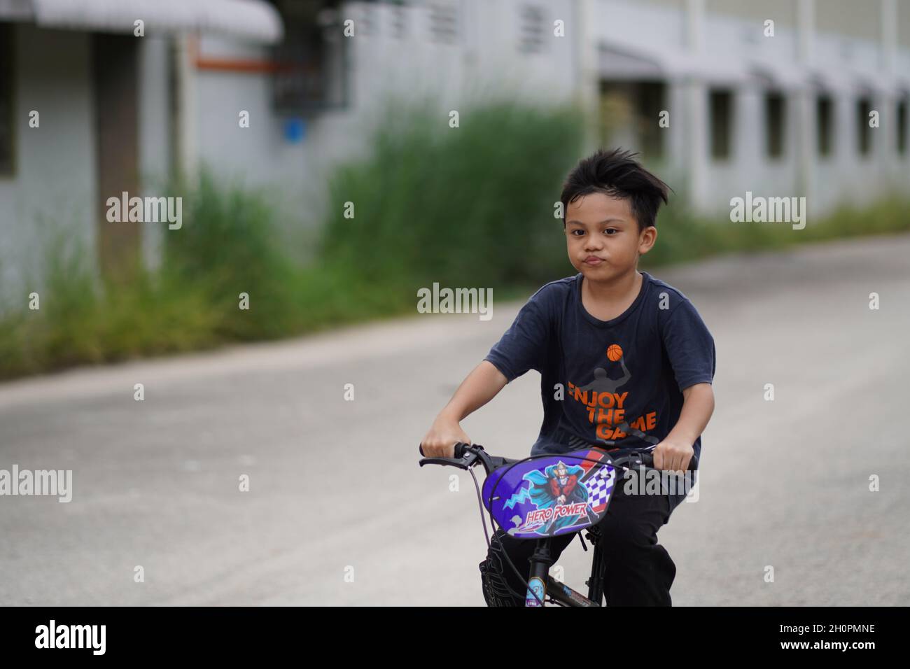 A kid riding his bicycle in the evening. Aktiviti basikal Malaysia ...