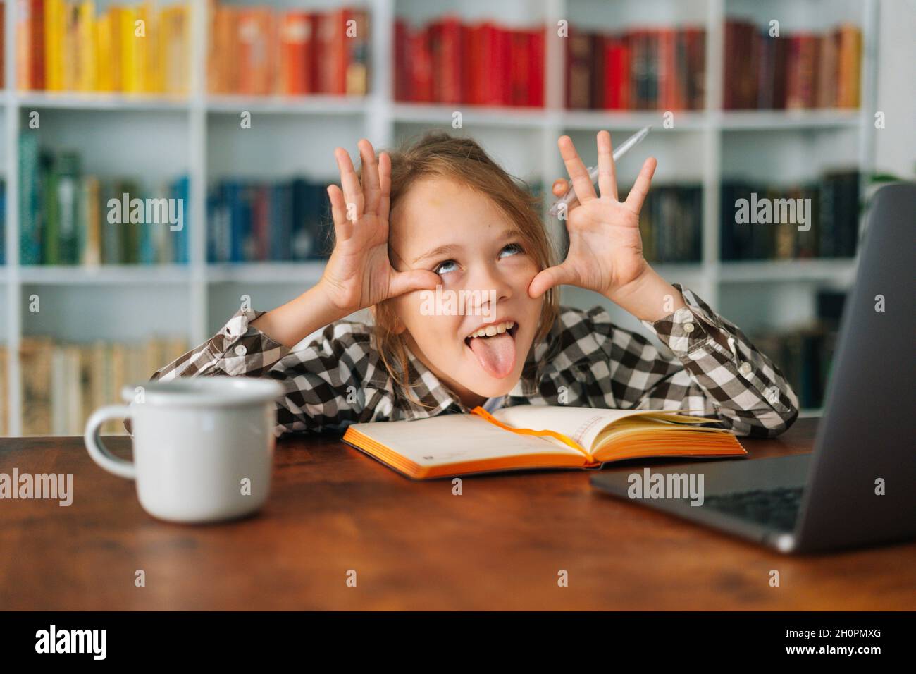 Close-up front view of happy pretty pupil child school girl fooling ...