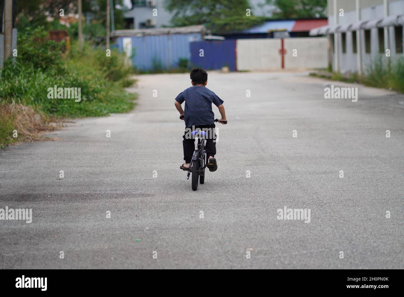 A kid riding his bicycle in the evening. Aktiviti basikal Malaysia ...