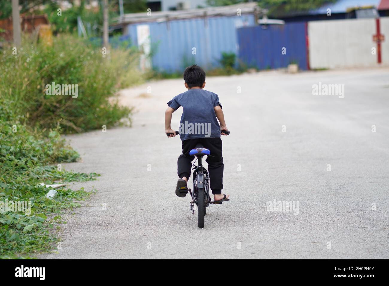 A kid riding his bicycle in the evening. Aktiviti basikal Malaysia ...