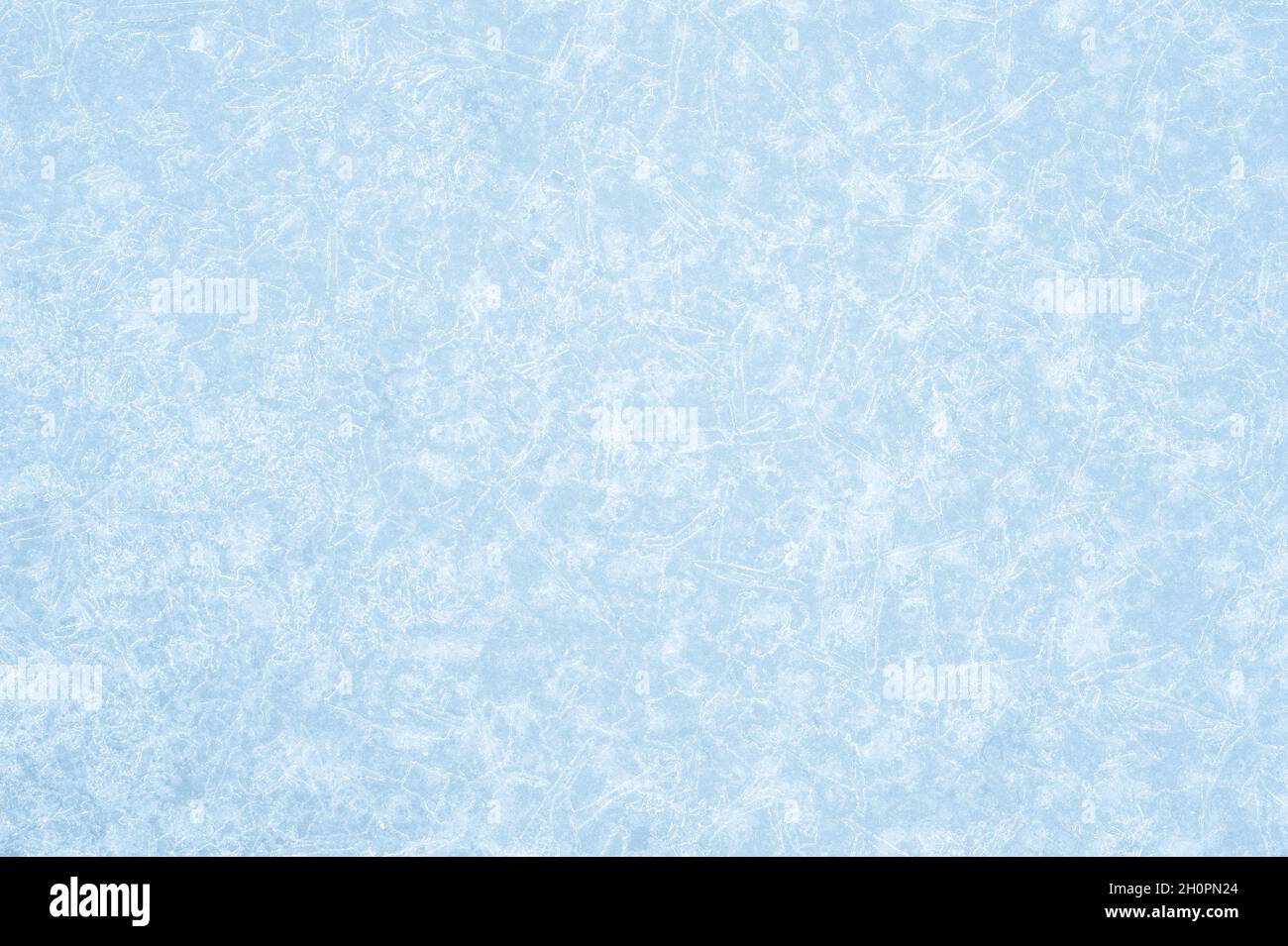 Pale blue ice in an openwork pattern of brightly glowing ice veins ...