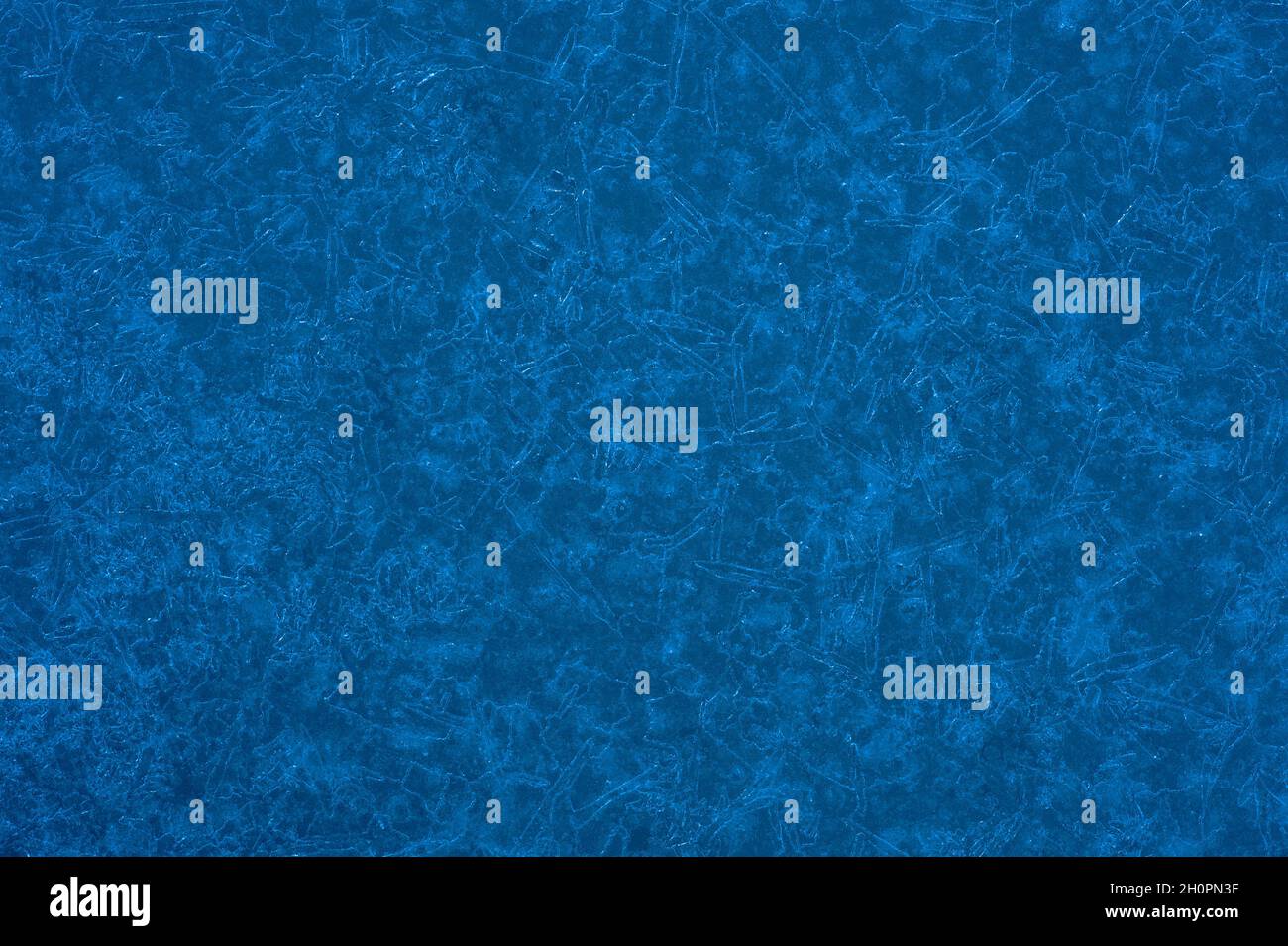 Dark blue ice background in an openwork pattern of glowing ice veins ...