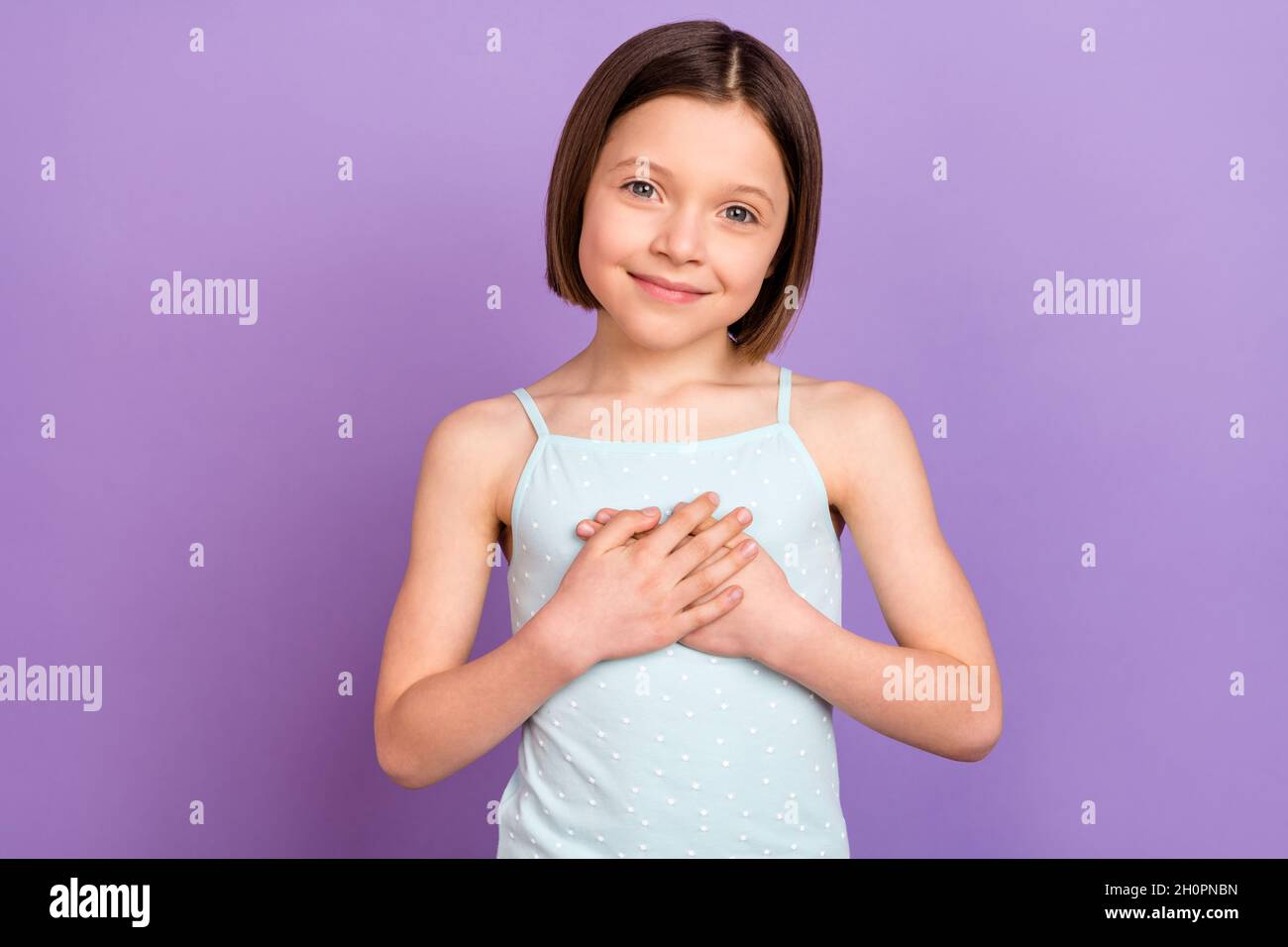 Photo of positive happy young little girl hold hands heart pledge ...