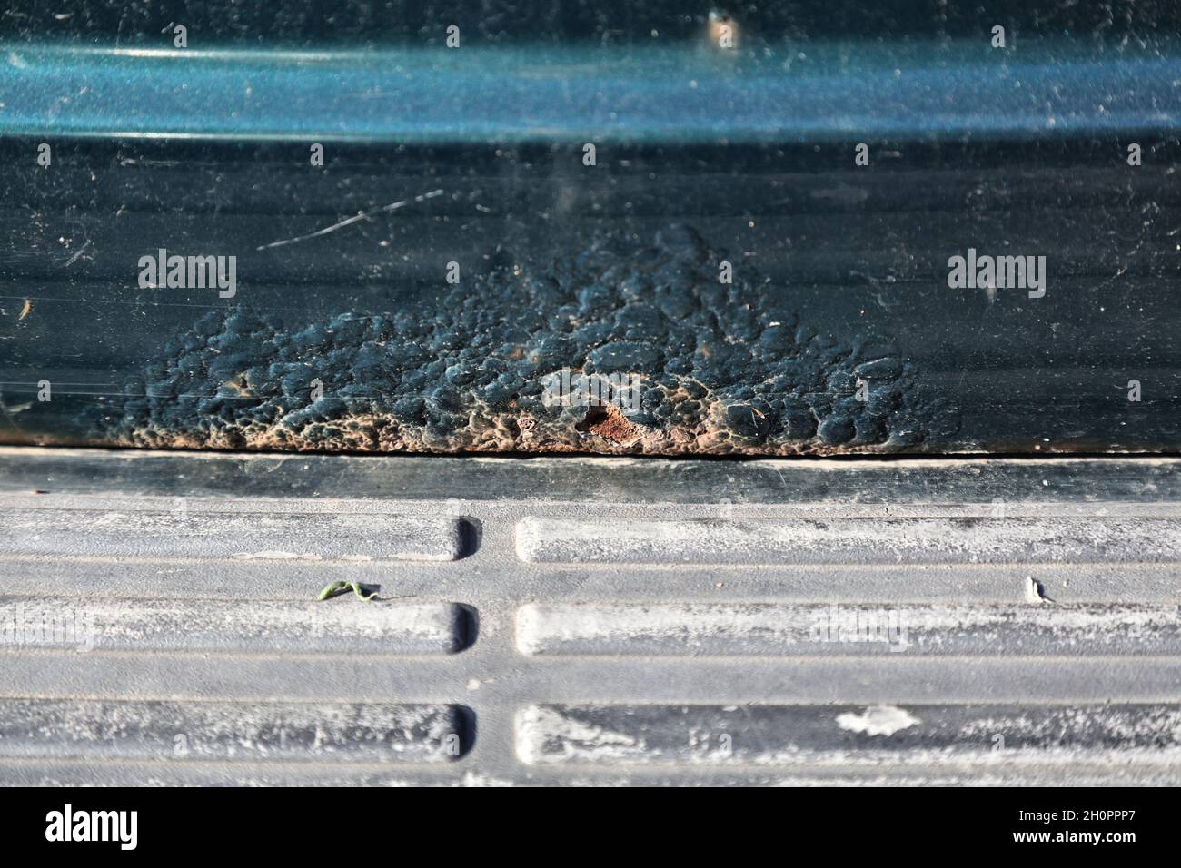 Rusting tailgate bottom sill in an old car. Weather damage in vehicle ...