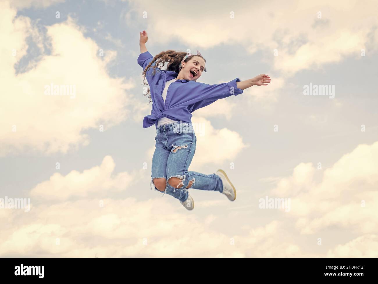 Fashion is her life. teen girl jumping high in the sky. having a party ...