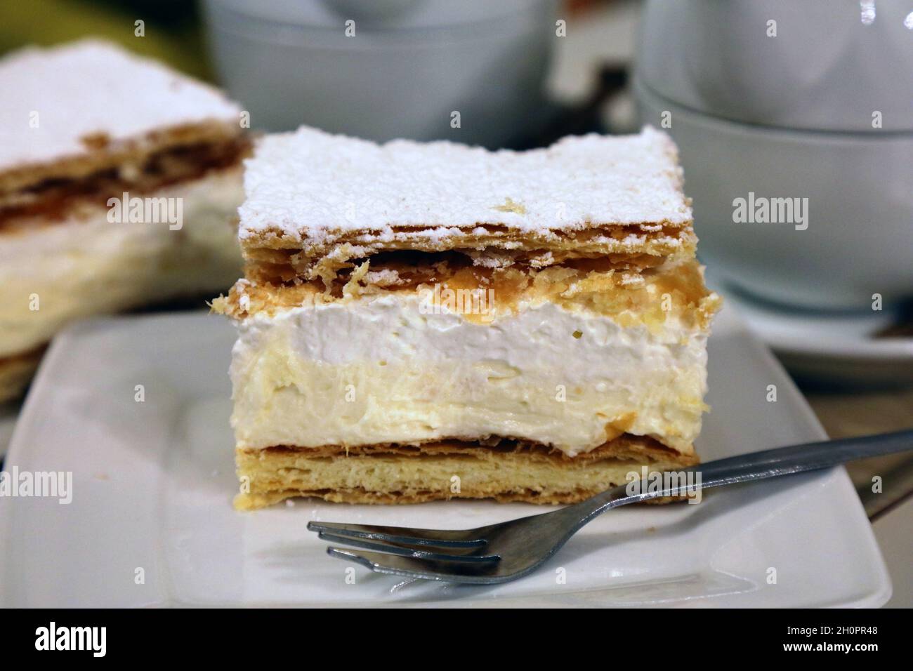 Kremowka cake in Poland. Traditional Polish sweet cuisine: cream cake ...