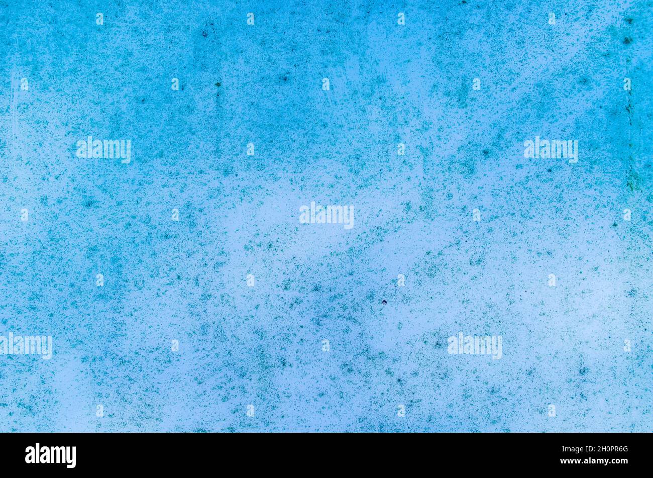 The texture of the painted wall. Blue background with dirt, dots and ...