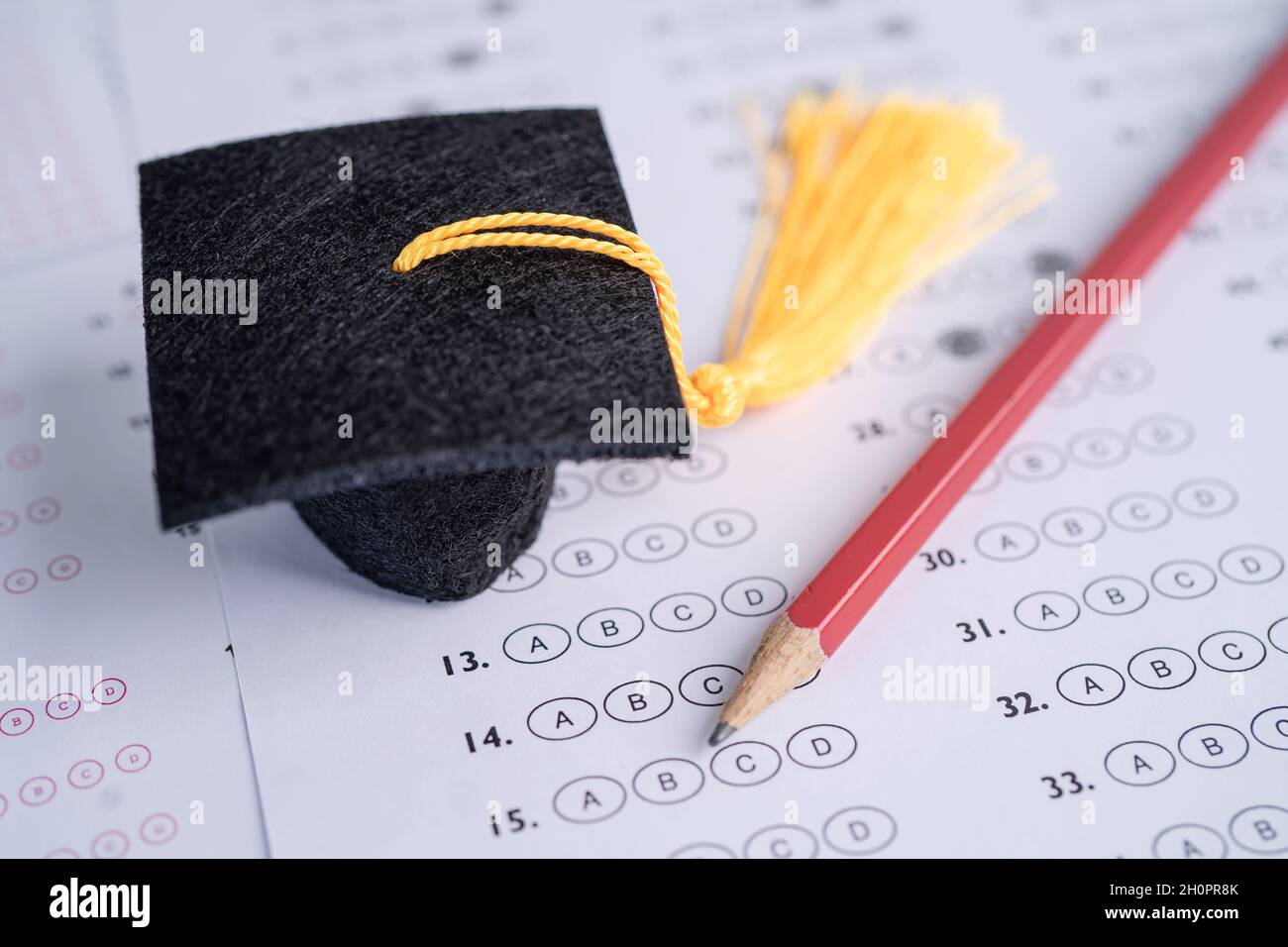 Graduation gap hat and pencil on answer sheet background, Education ...