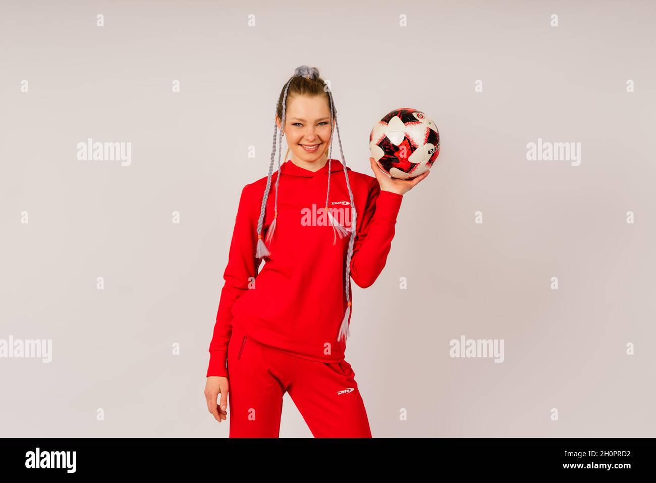 Female football fan in sport style with soccer ball. Studio shot ...
