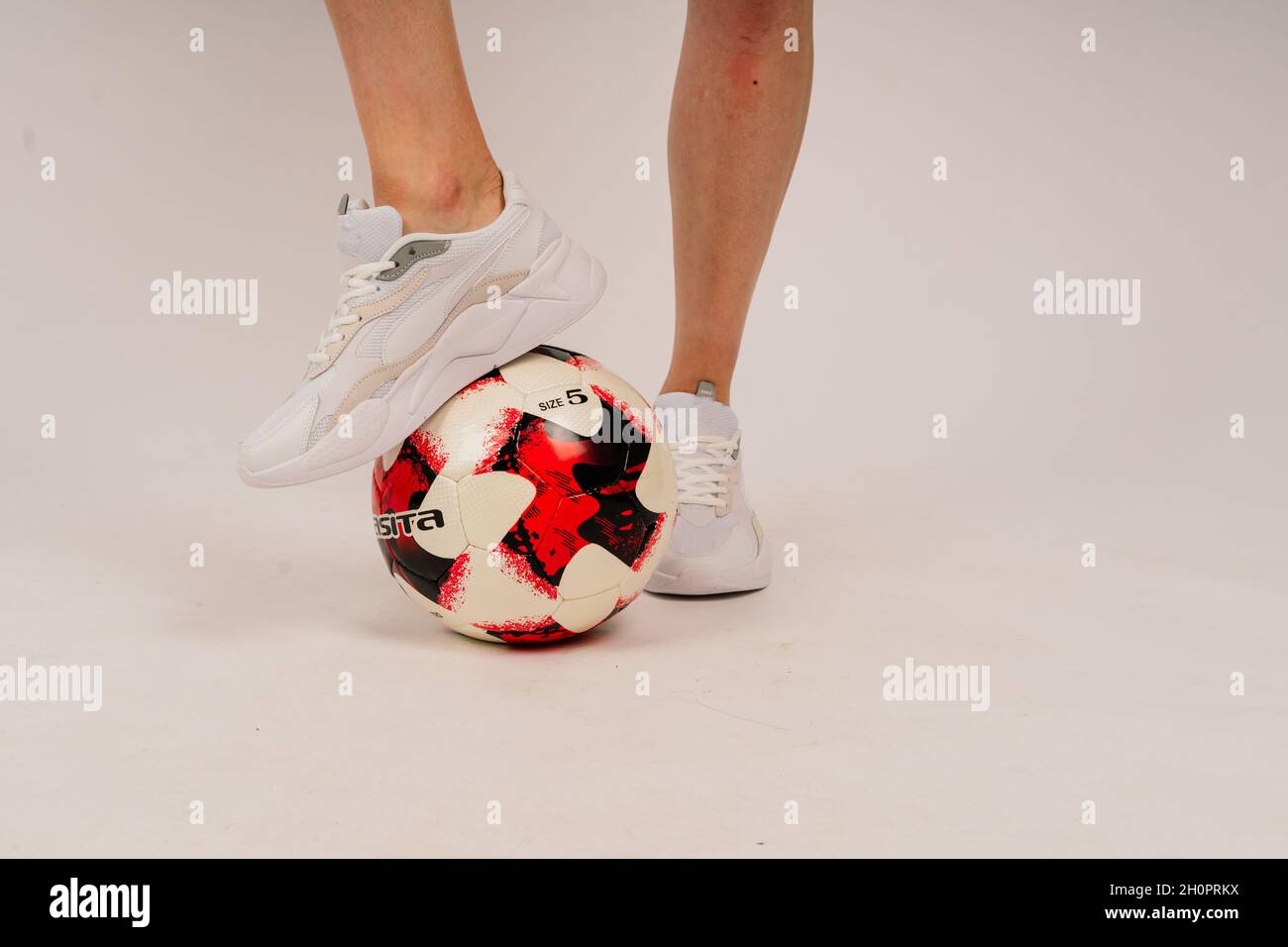 Female football fan in sport style with soccer ball. Studio shot ...