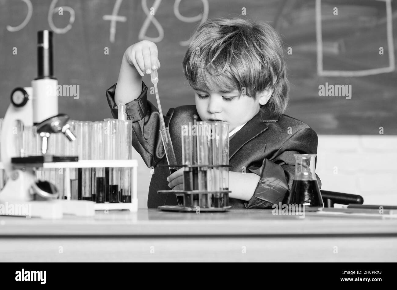 microscope at lab. small boy using microscope at lesson. student do ...
