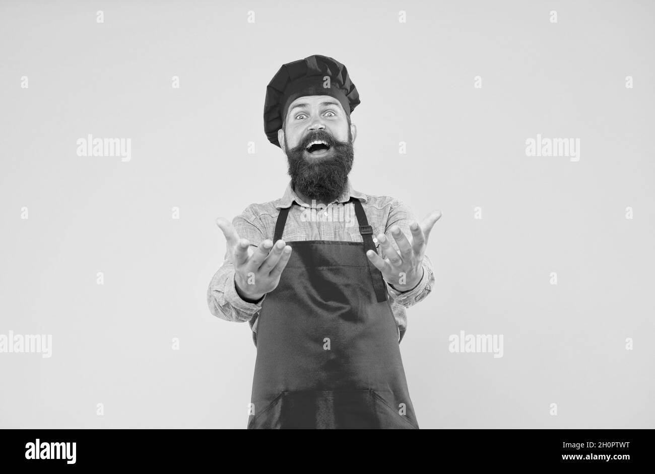 Cook bearded man excited about delicious meals, welcome guests Stock ...