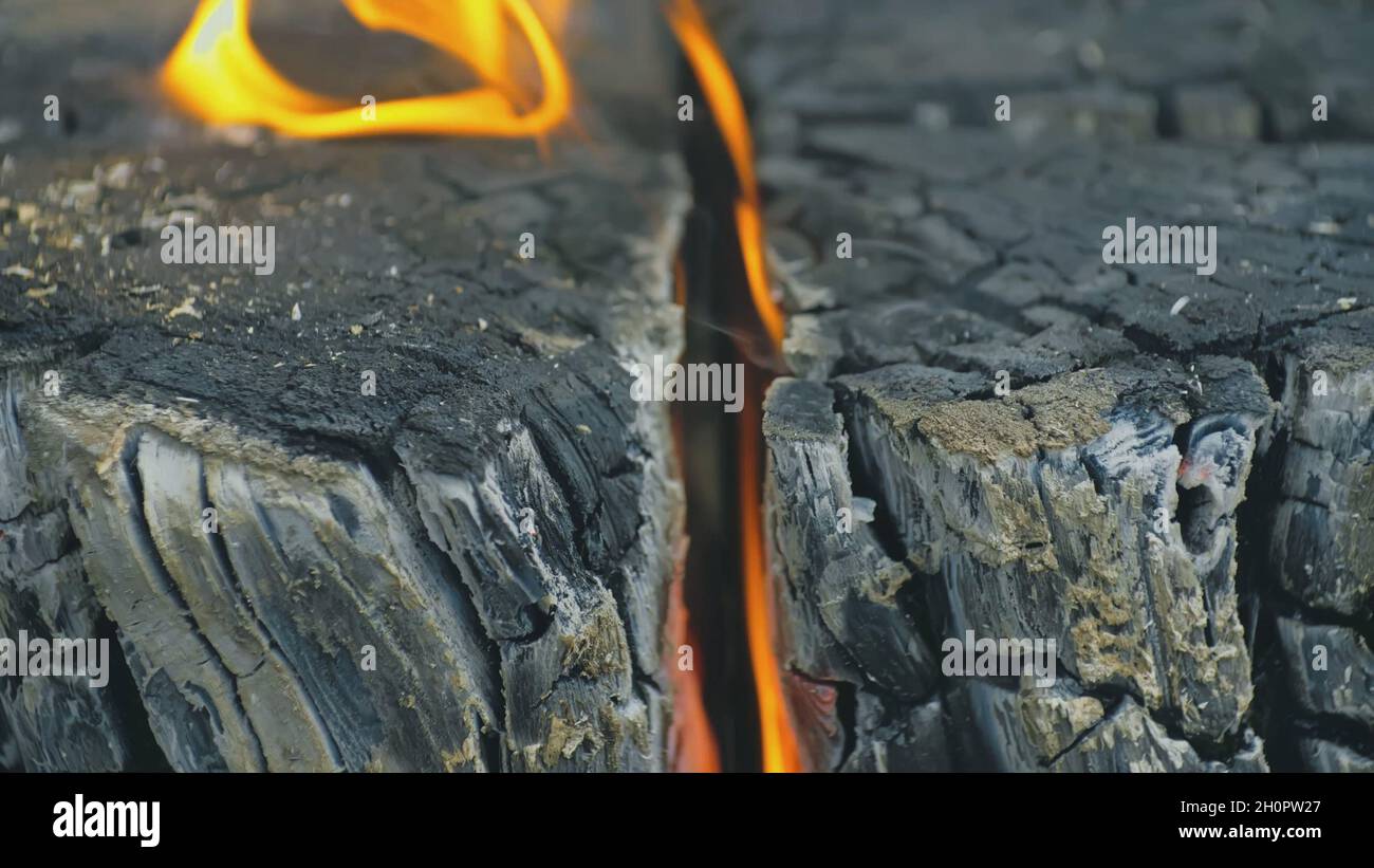Swedish or finnish log candle. Fire burning from inside the wooden log ...