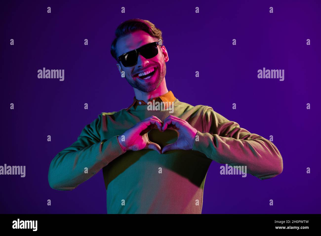 Photo of young cheerful man happy positive smile show fingers heart ...