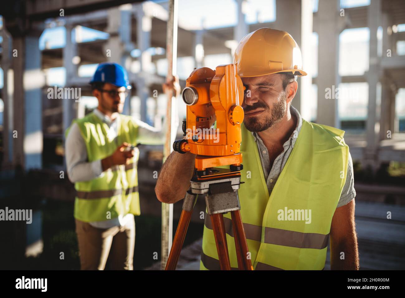 Engineer surveyor working with theodolite at construction site Stock ...