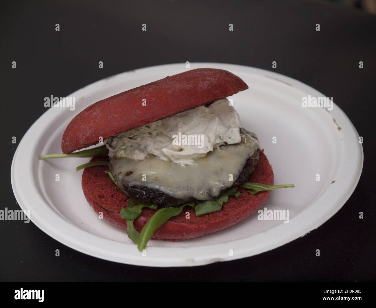 Red bun burger with meat, melted cheese and a white sauce Stock Photo ...