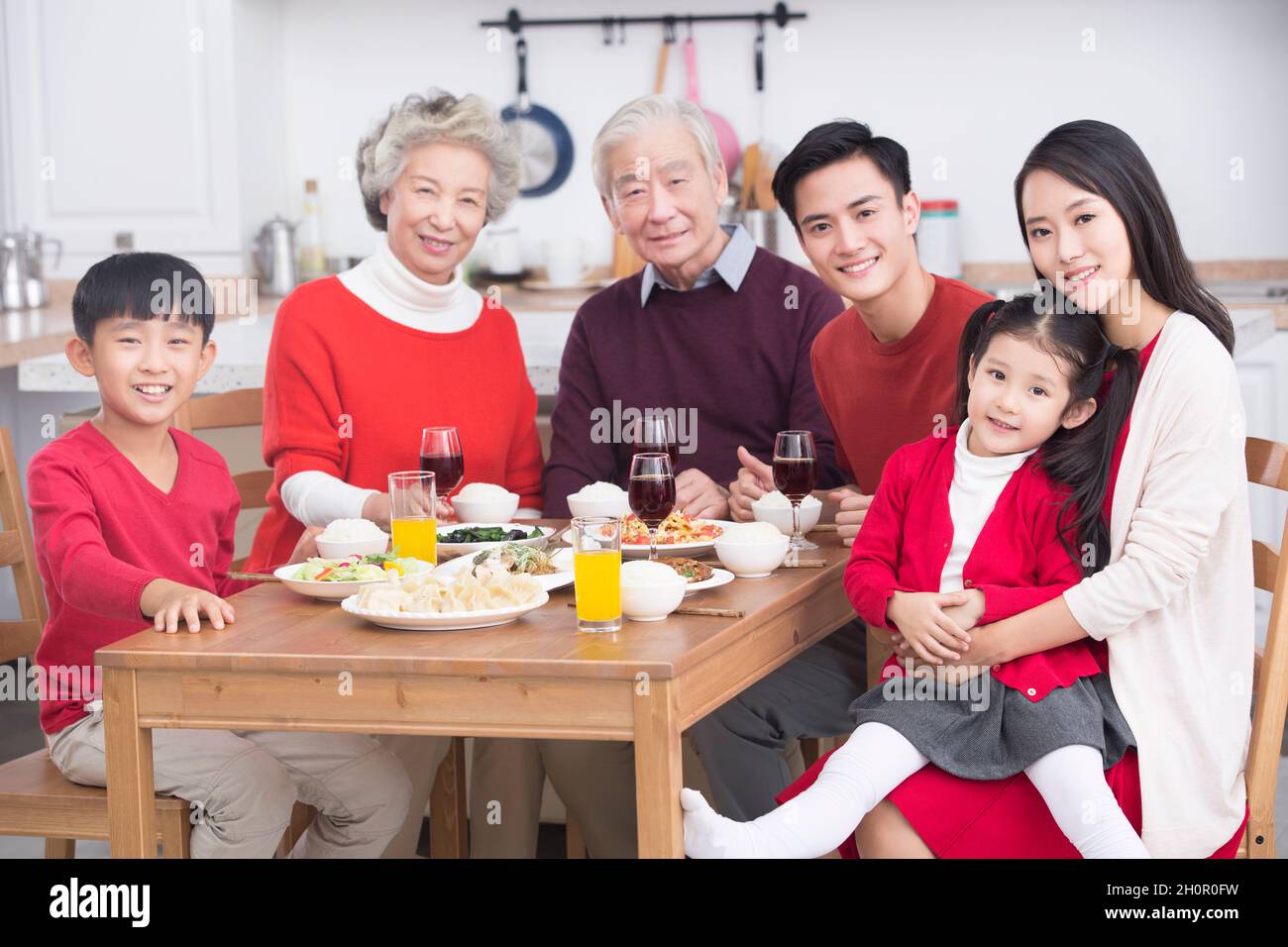 Three generation family around dining table hi-res stock photography ...