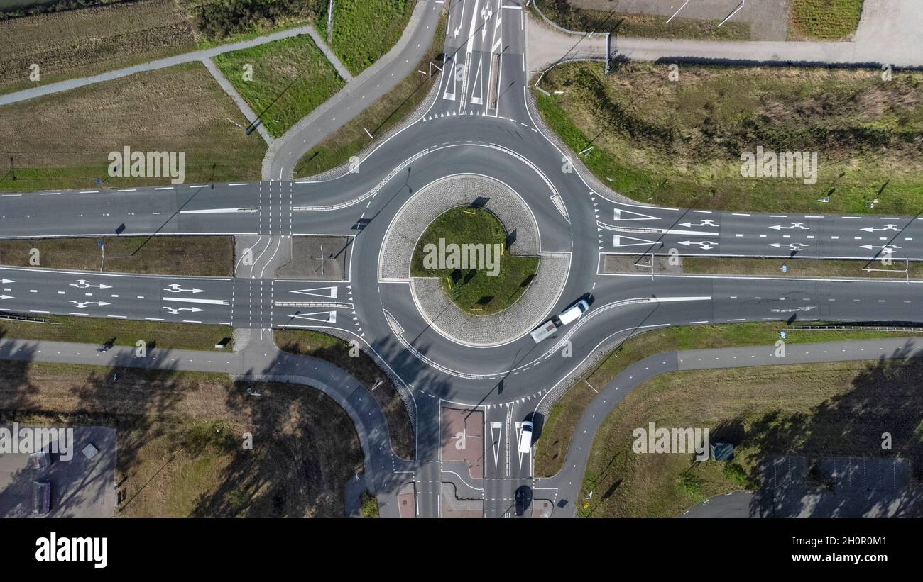 Top down aerial drone view of a small traffic roundabout in the ...