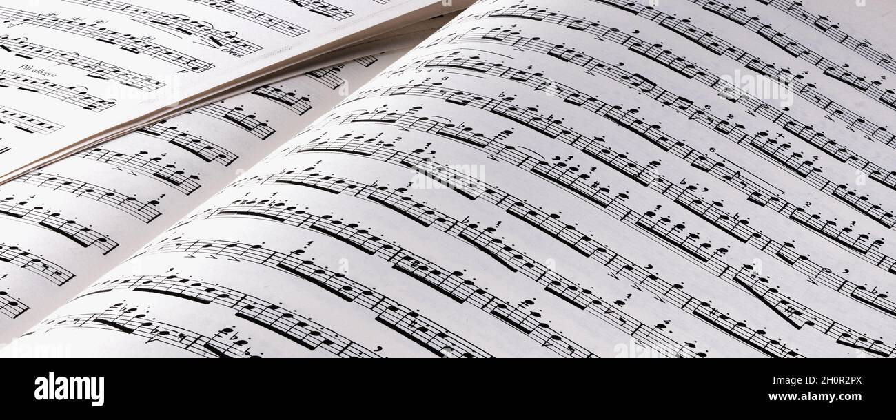 A music book open with music notes in black and white Stock Photo - Alamy