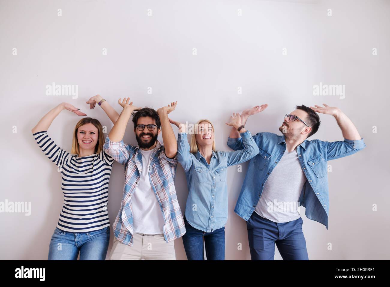 Small group of people lifting hands in the air like they holding ...